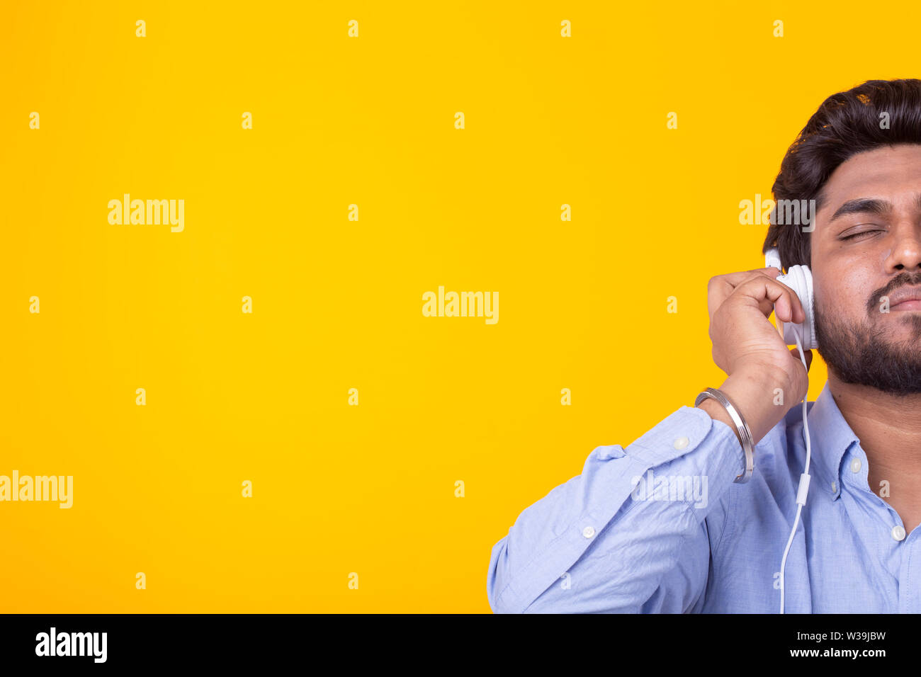 Music, meloman and people concept - A happy indian man listening to ...