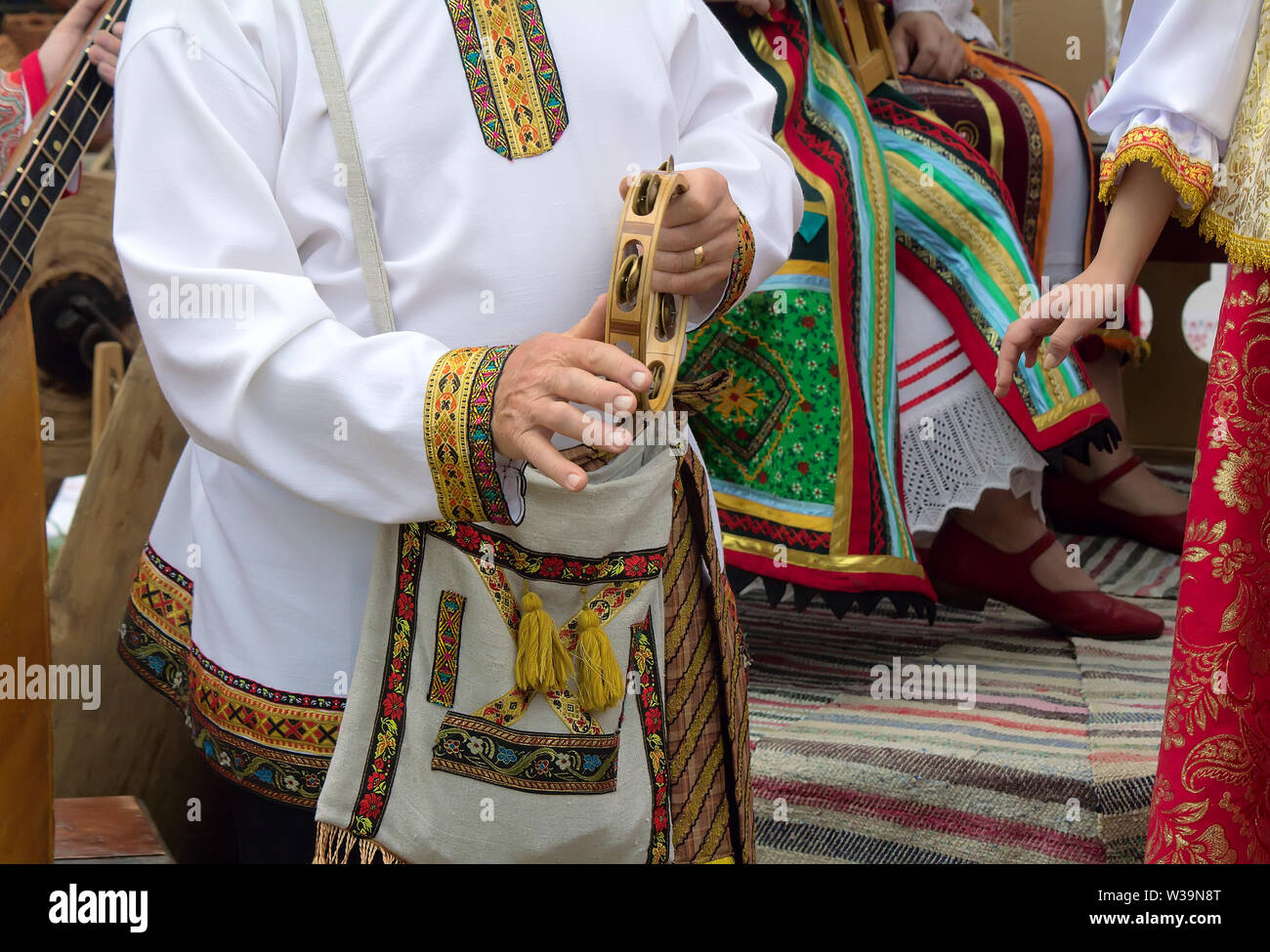 A man in national dress plays in the ensemble on an old folk musical ...
