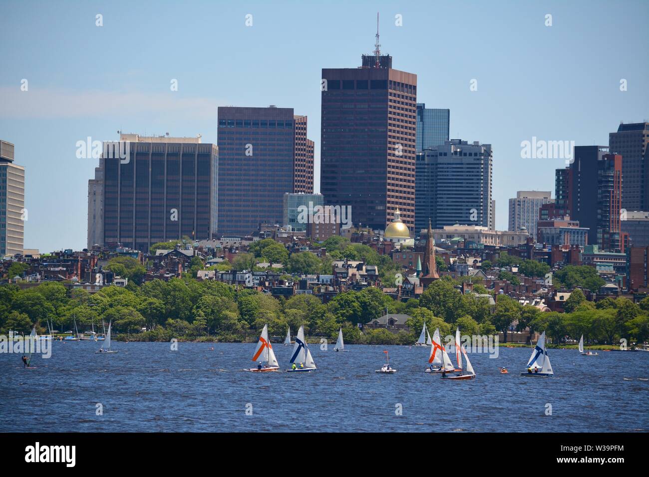 Sailboats sailing in the Charles River Basin with the Boston skyline ...