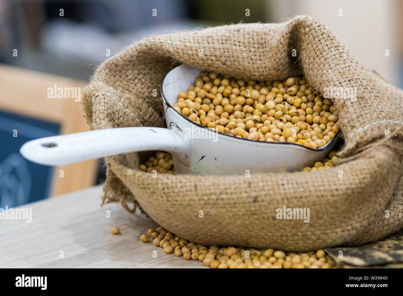 Soybean In sacks on wooden background Stock Photo - Alamy