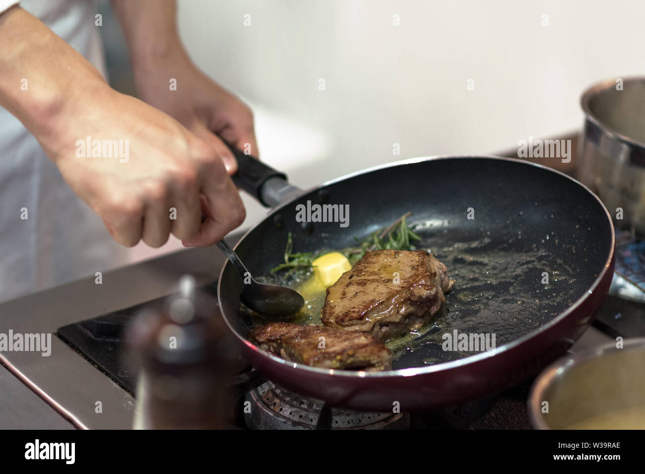 Chef cooking food in the kitchen, Chef preparing food Stock Photo - Alamy
