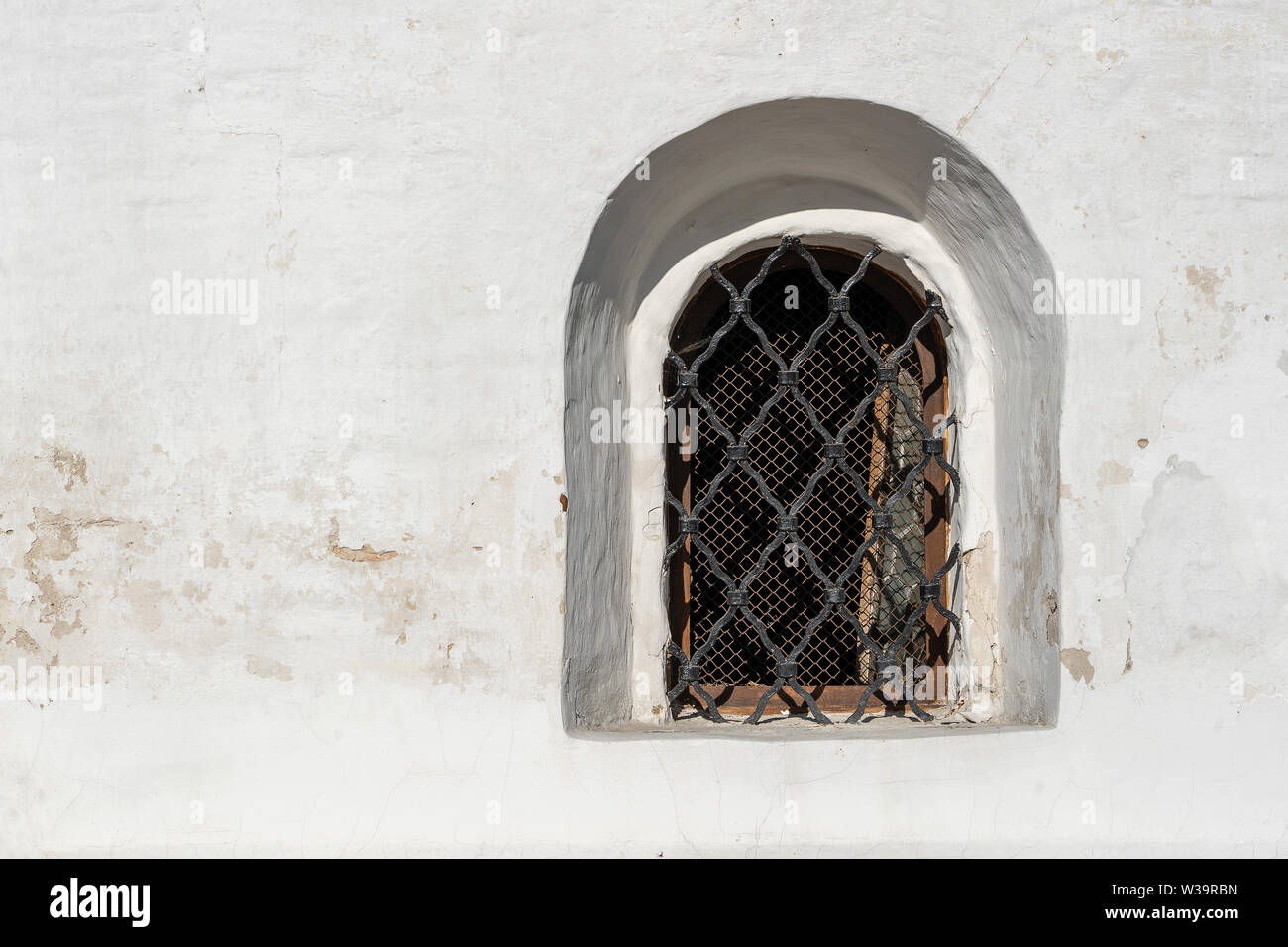 An ancient window in the white wall on the street in Kiev, Ukraine ...