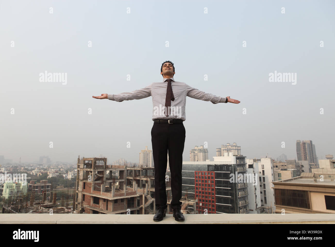 Businessman standing with his arm outstretched Stock Photo - Alamy