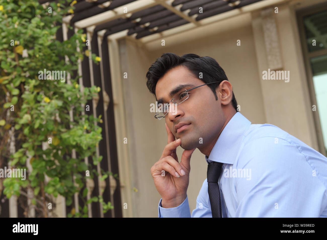 Indian businessman thinking Stock Photo - Alamy