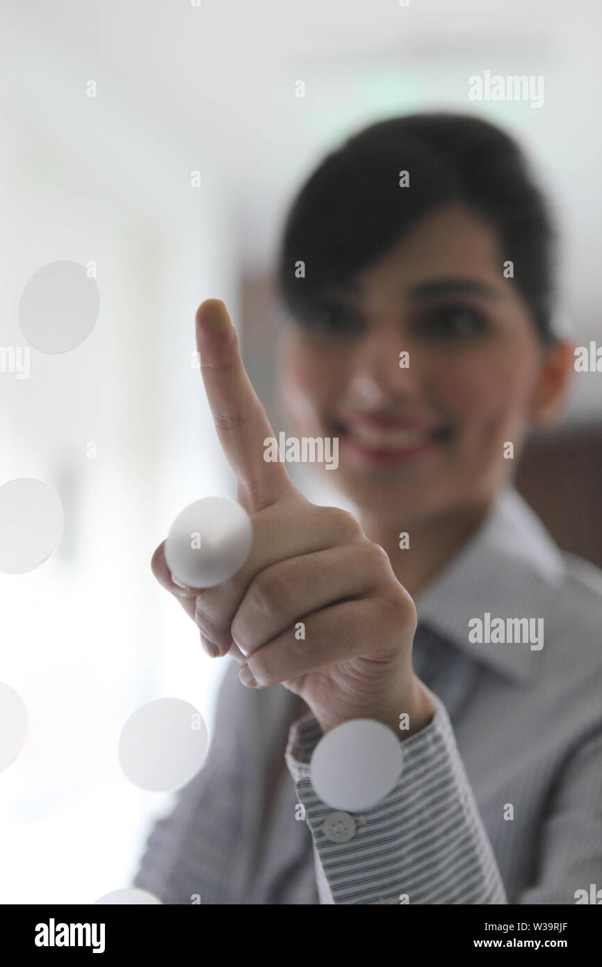 Businesswoman touching glass window Stock Photo - Alamy