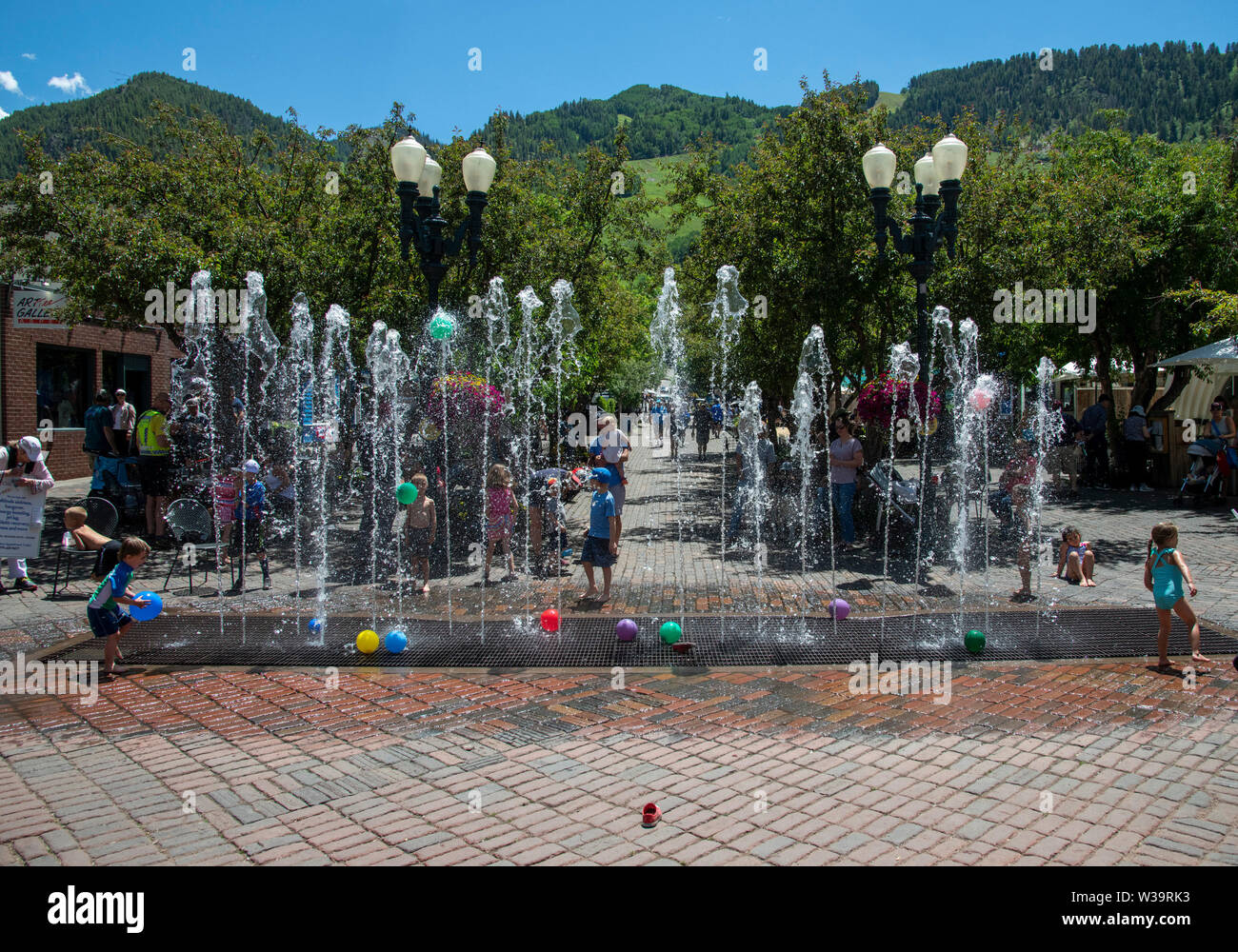 July 05, 2019: Children play in a water fountain in downtown Aspen ...