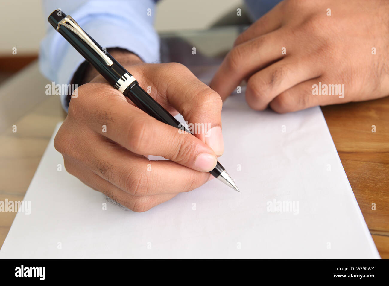 Indian businessman signing a document Stock Photo - Alamy