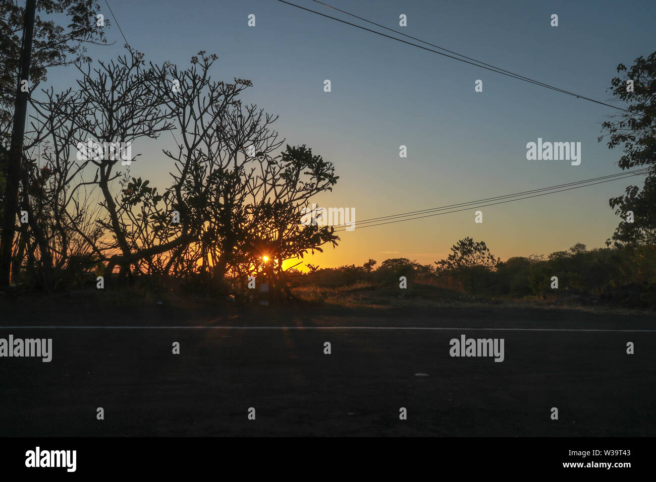 Beautiful sunset over roads treetops hi-res stock photography and ...