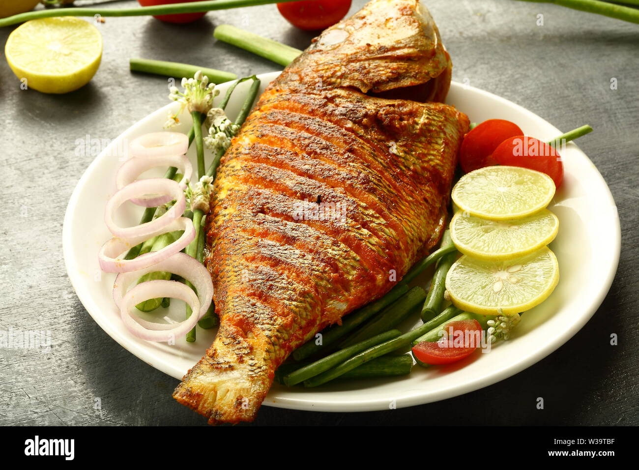 Fresh fried fish served with green salad Stock Photo - Alamy