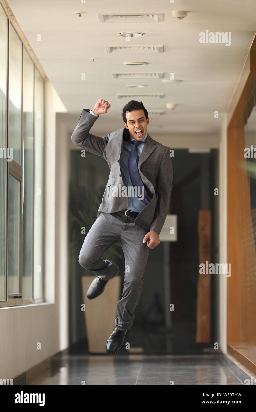 Businessman punching the air Stock Photo - Alamy