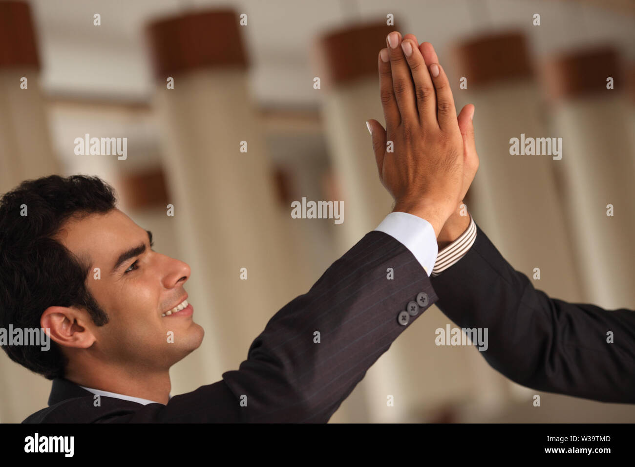 Two business executives giving high fives Stock Photo - Alamy