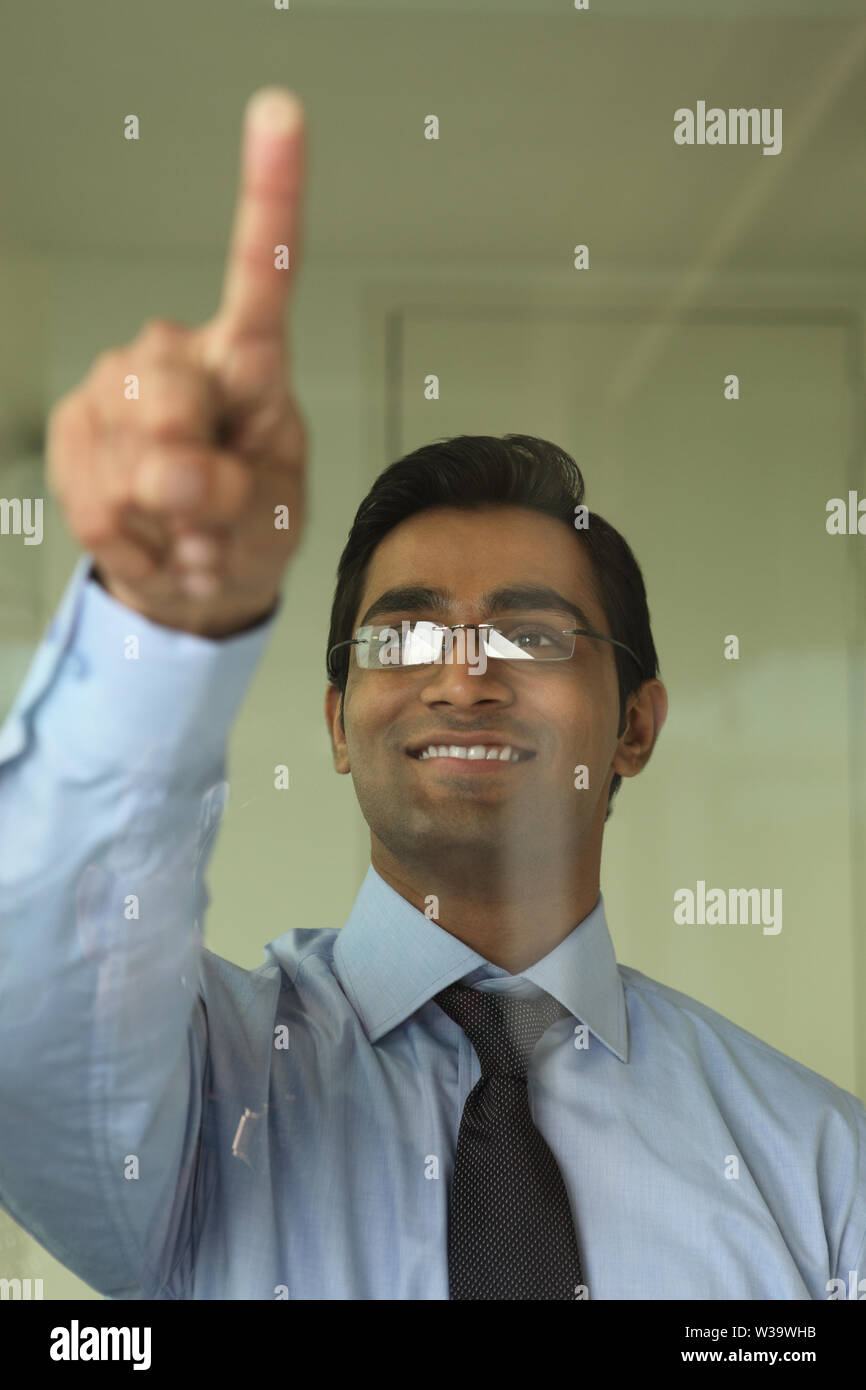 Businessman touching glass Stock Photo - Alamy