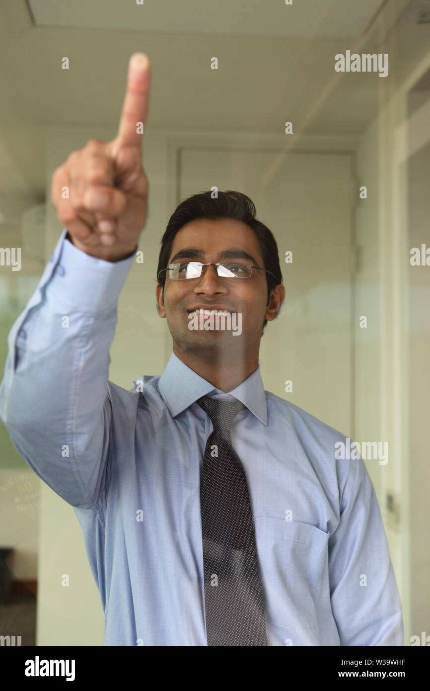 Businessman touching glass Stock Photo - Alamy