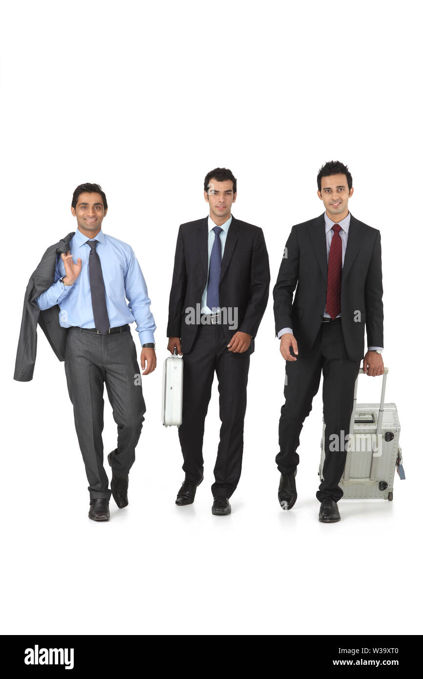 Three business executives walking Stock Photo - Alamy