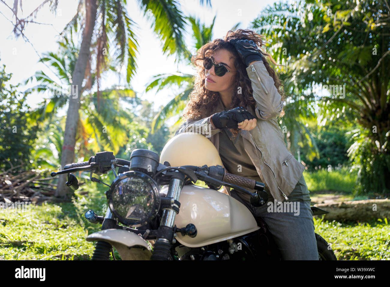 Beautiful female biker driving a cafe' racer motorbike - Pretty girl ...