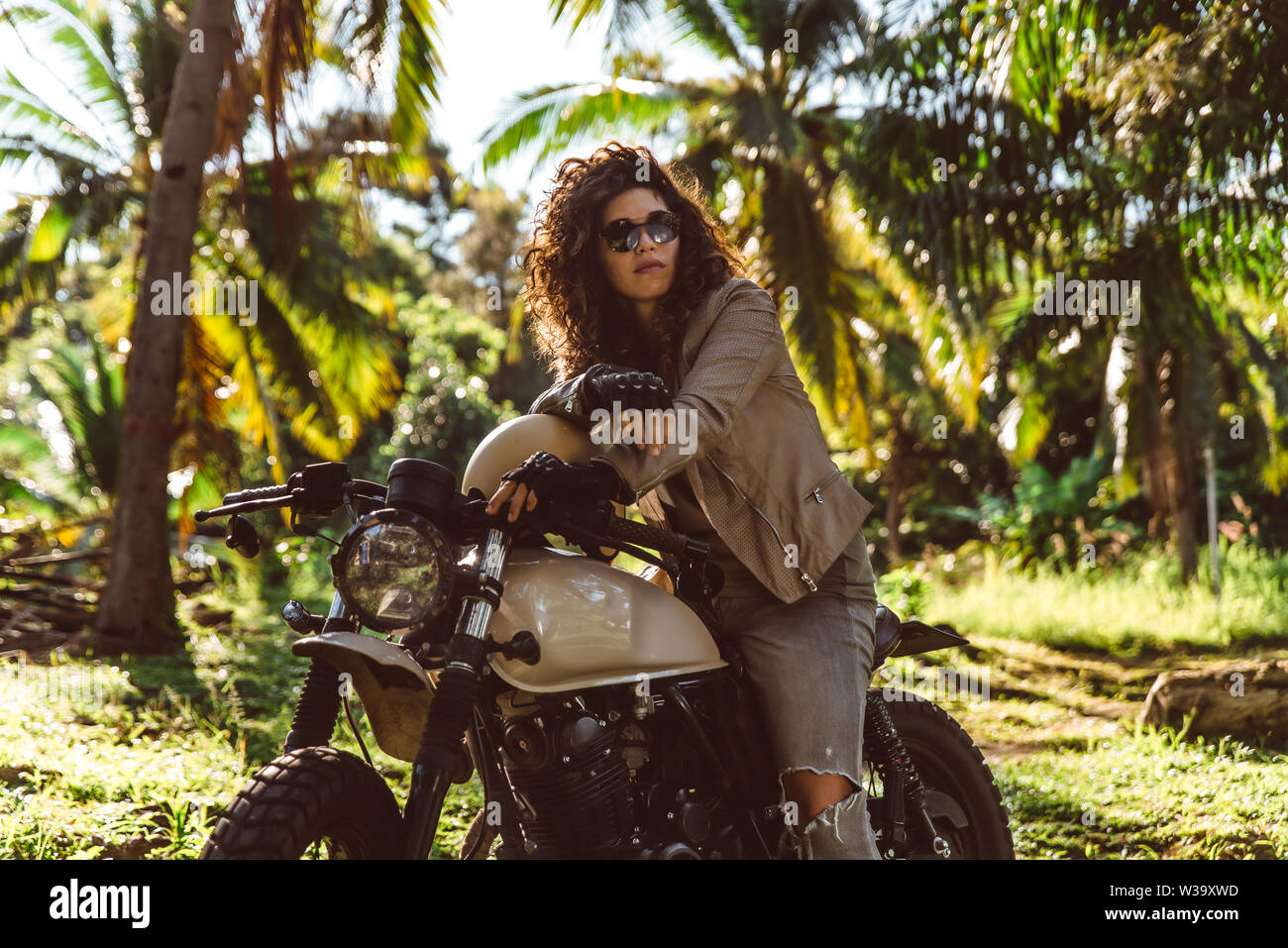 Beautiful female biker driving a cafe' racer motorbike - Pretty girl ...