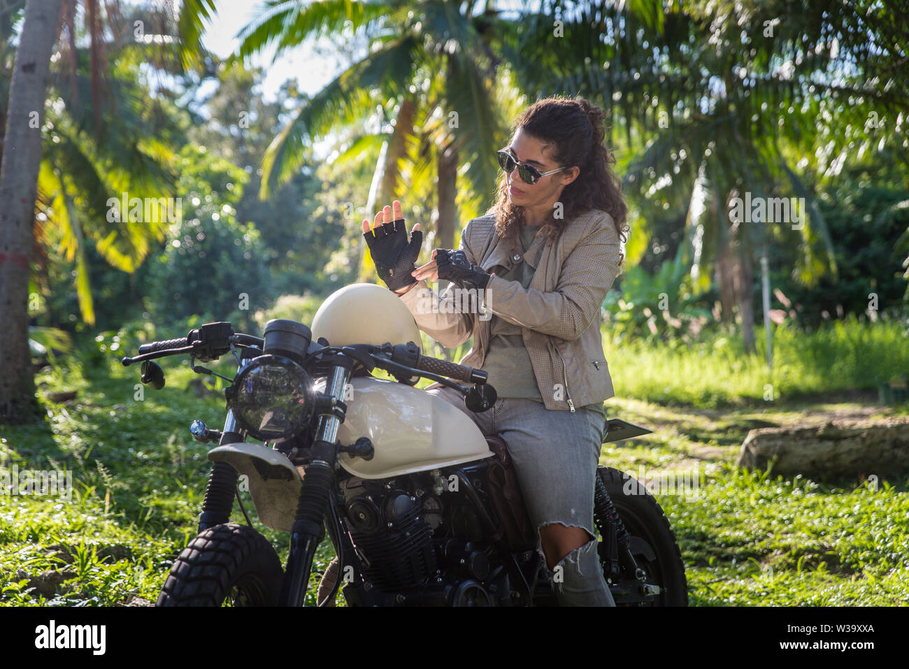 Beautiful female biker driving a cafe' racer motorbike - Pretty girl ...