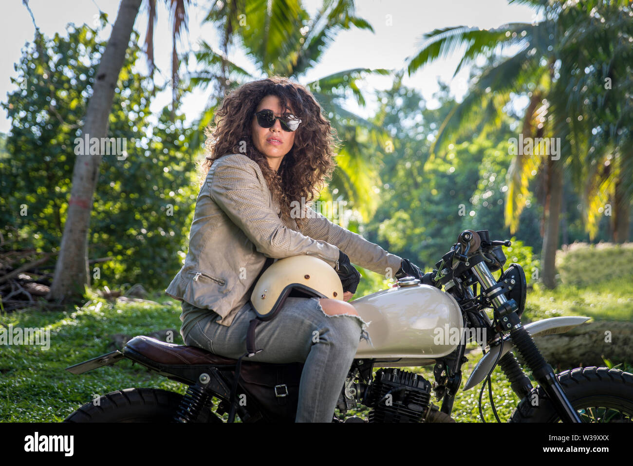 Beautiful female biker driving a cafe' racer motorbike - Pretty girl ...