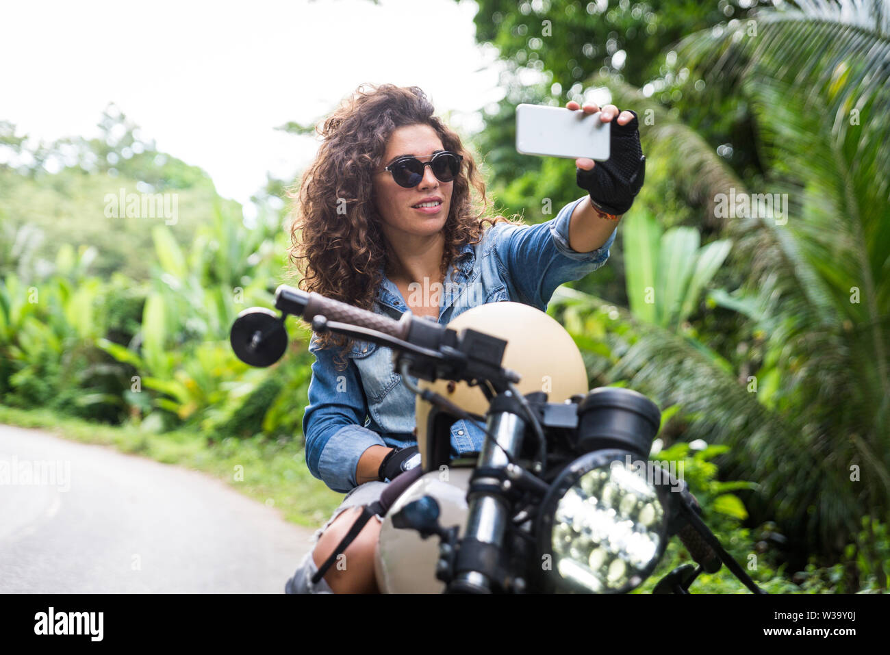 Beautiful female biker driving a cafe' racer motorbike - Pretty girl ...