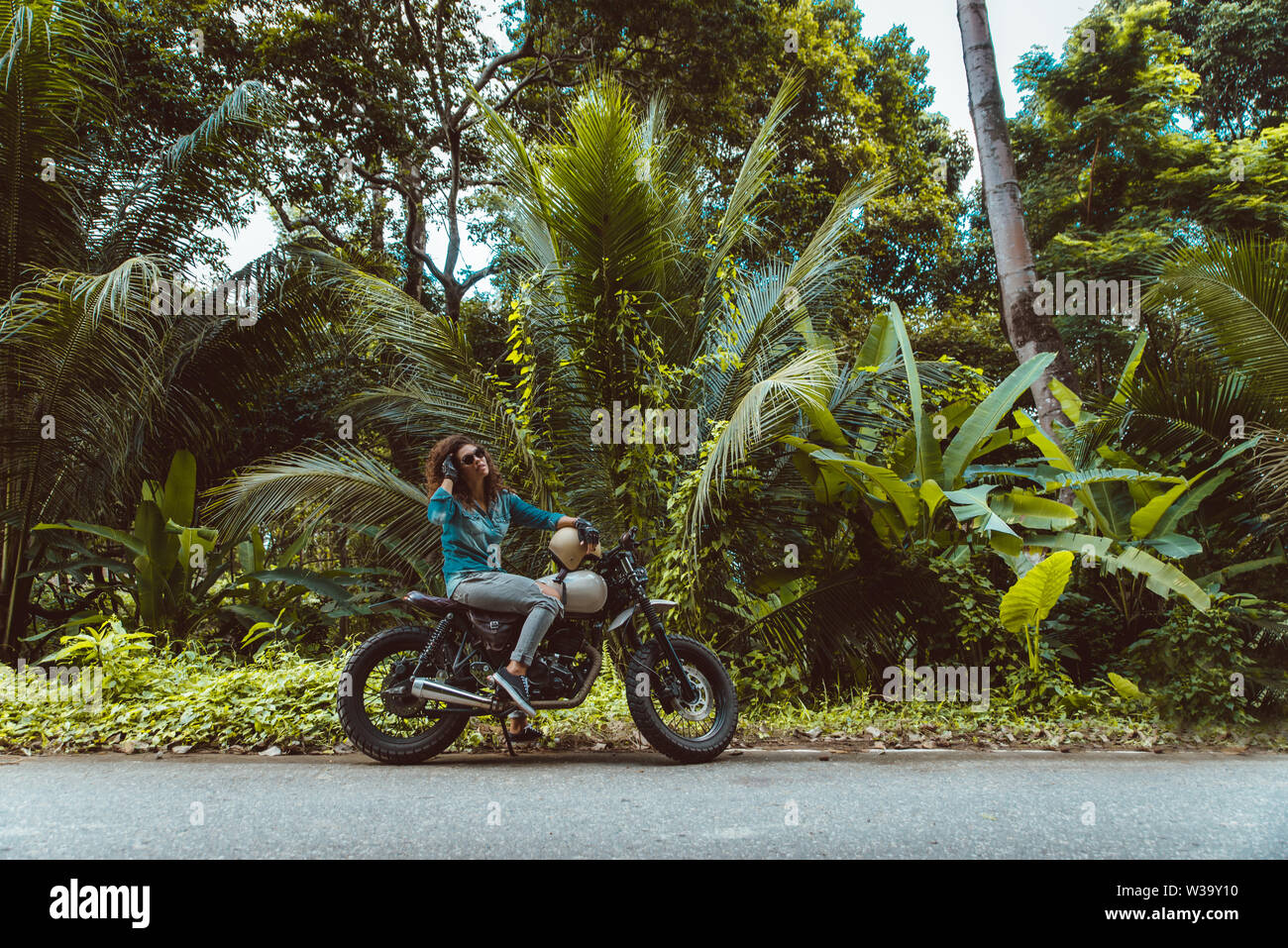 Beautiful female biker driving a cafe' racer motorbike - Pretty girl ...