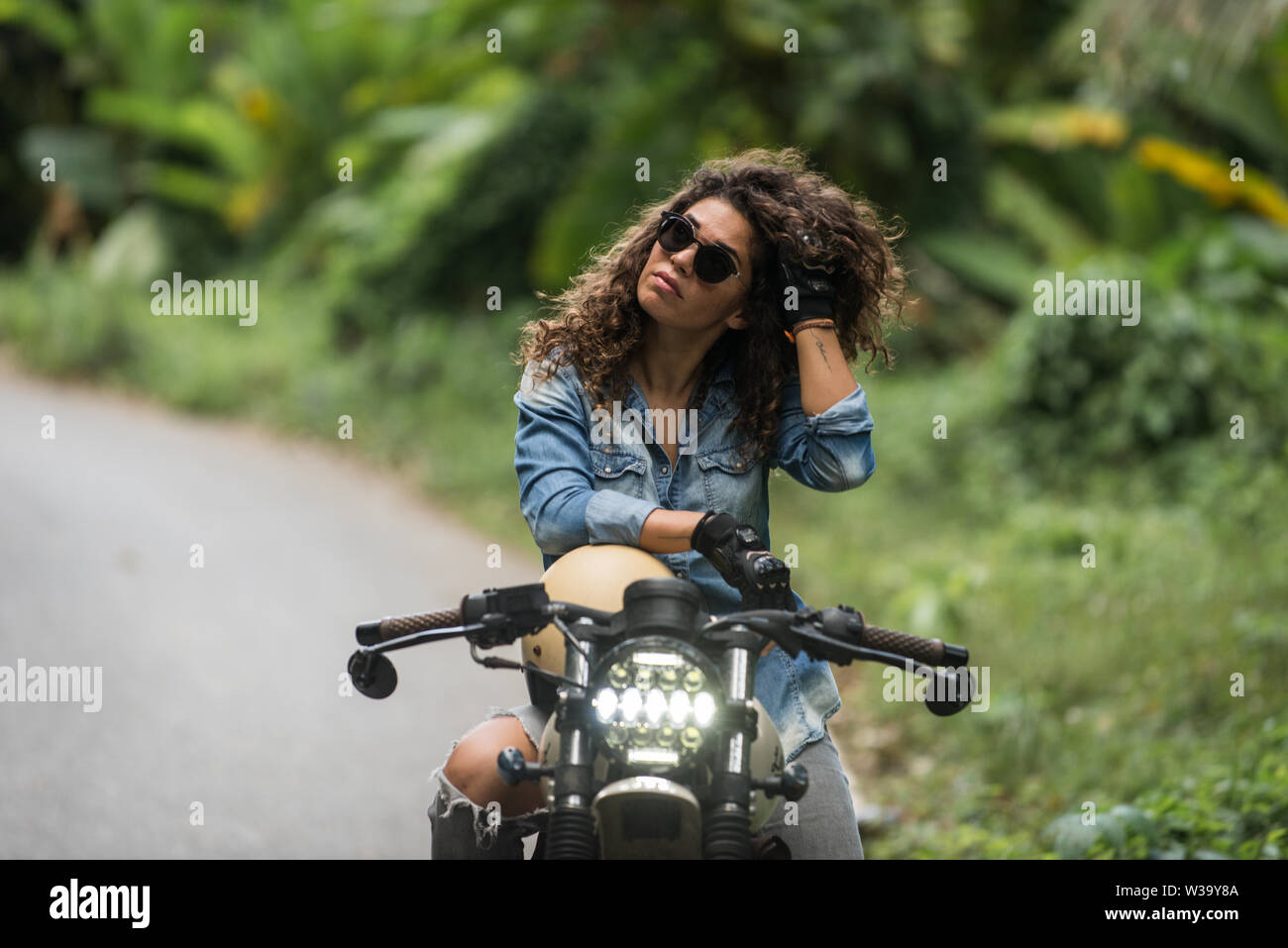 Beautiful female biker driving a cafe' racer motorbike - Pretty girl ...