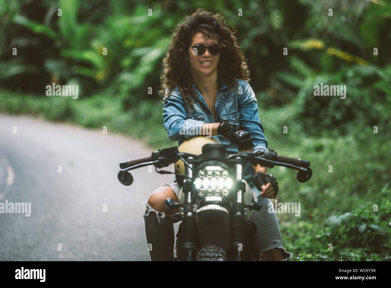 Beautiful female biker driving a cafe' racer motorbike - Pretty girl ...