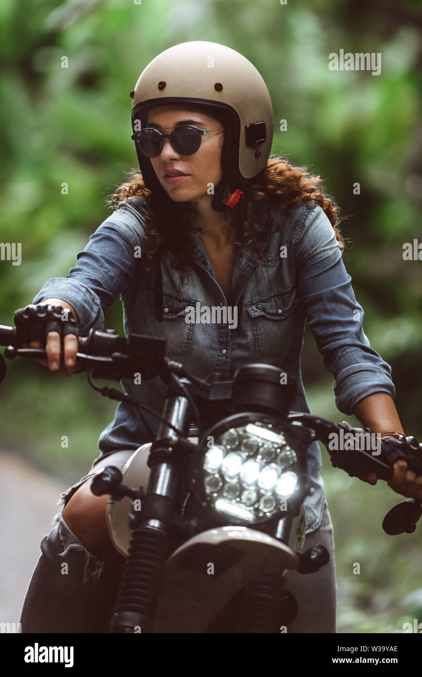 Beautiful female biker driving a cafe' racer motorbike - Pretty girl ...