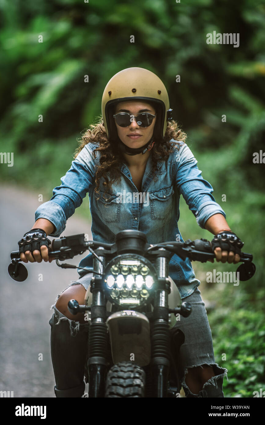 Beautiful female biker driving a cafe' racer motorbike - Pretty girl ...