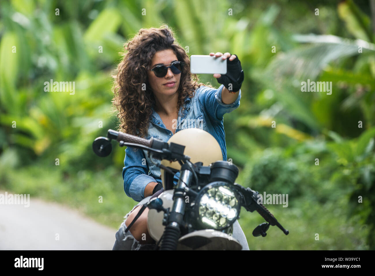Beautiful female biker driving a cafe' racer motorbike - Pretty girl ...