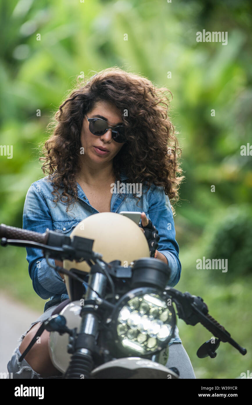 Beautiful female biker driving a cafe' racer motorbike - Pretty girl ...