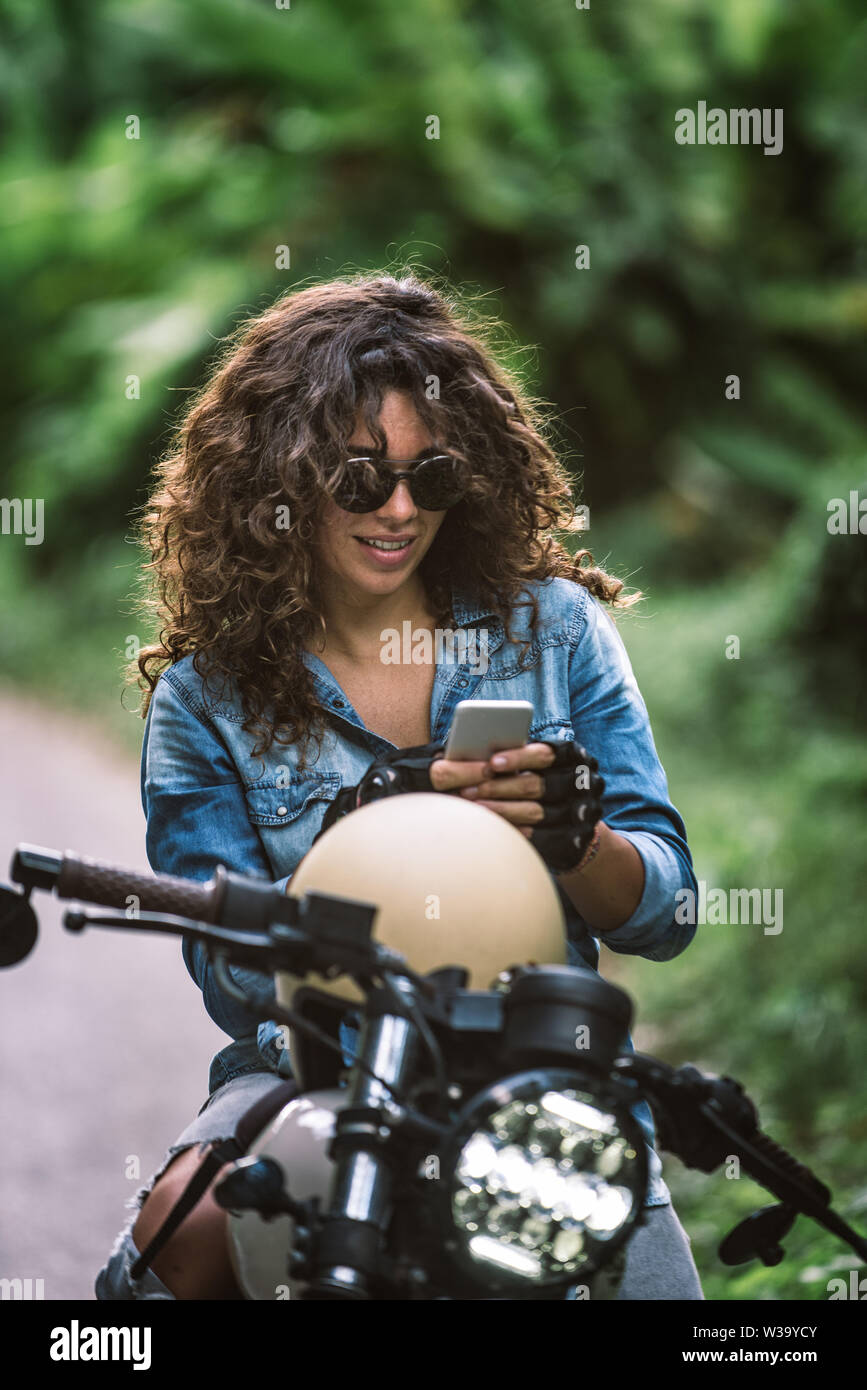 Beautiful female biker driving a cafe' racer motorbike - Pretty girl ...