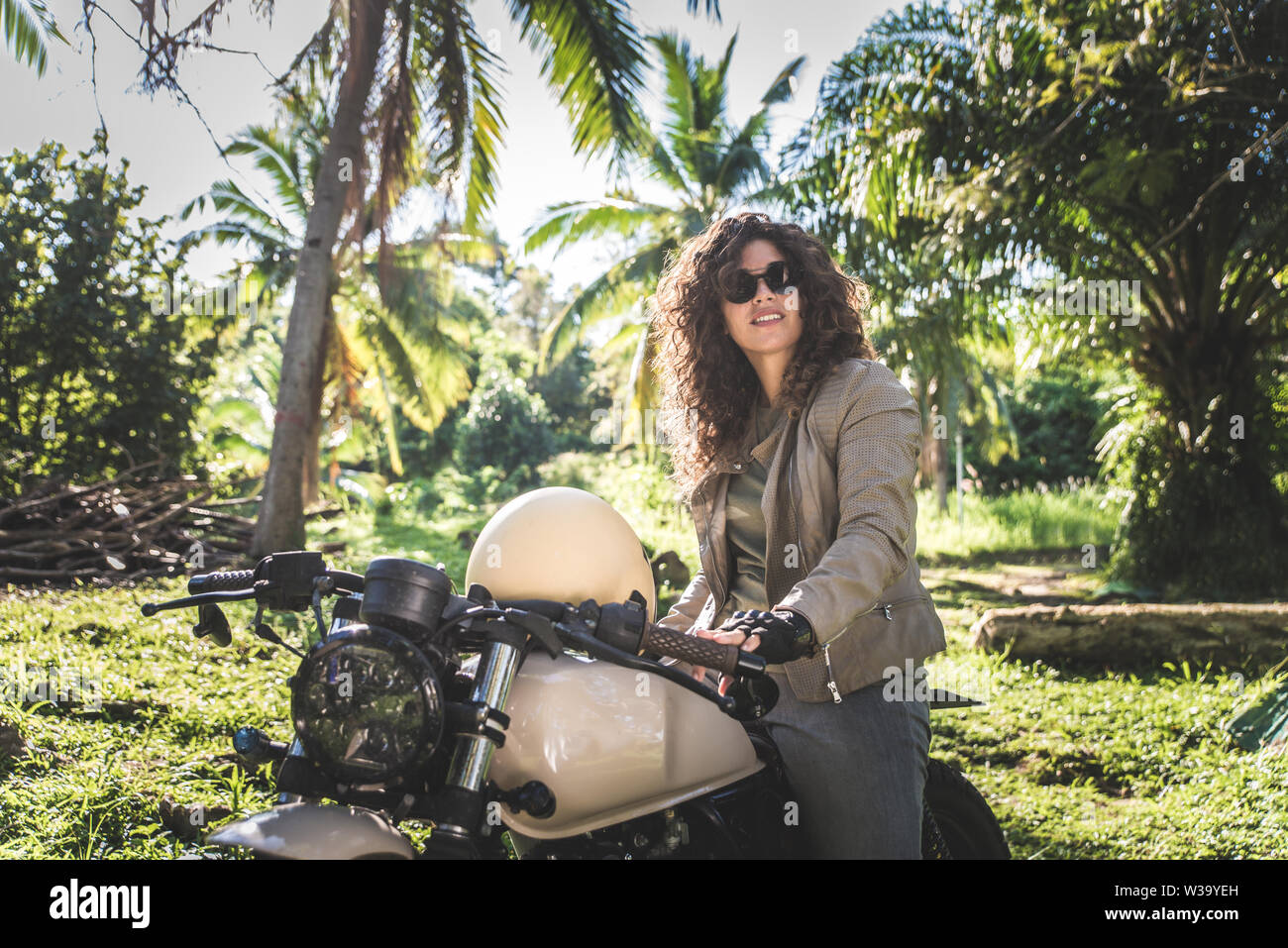 Beautiful female biker driving a cafe' racer motorbike - Pretty girl ...