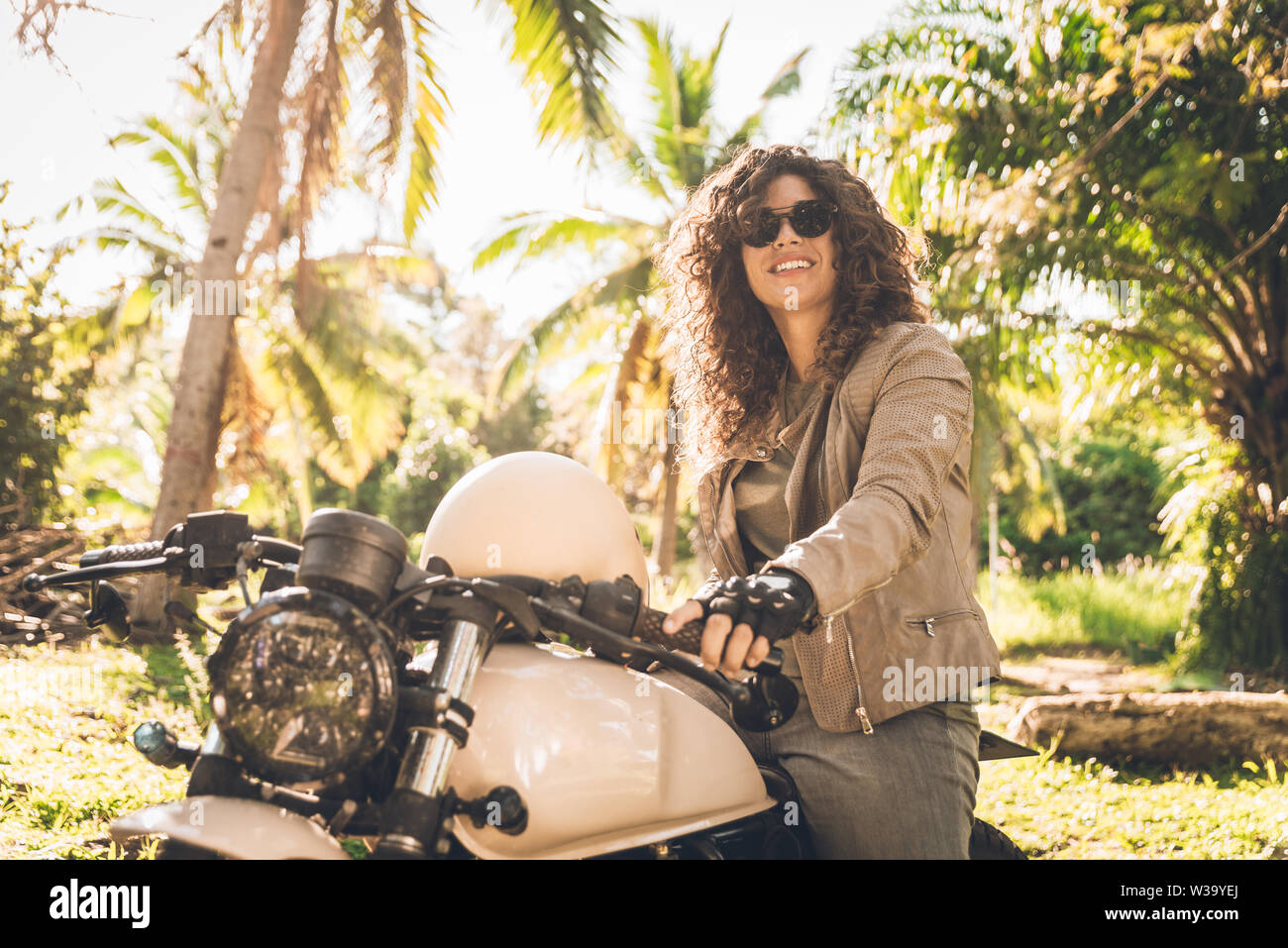Beautiful female biker driving a cafe' racer motorbike - Pretty girl ...