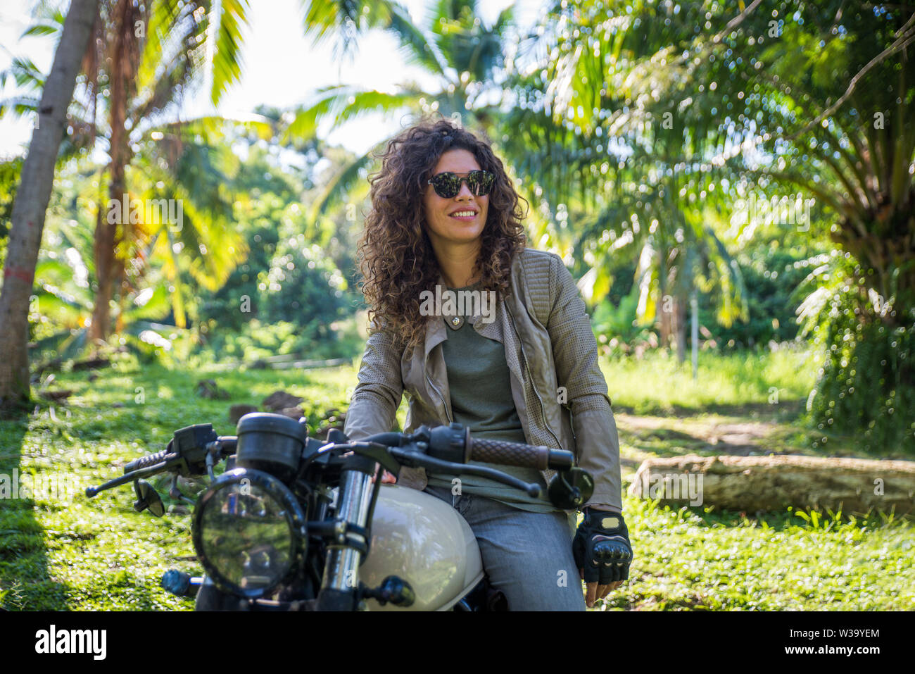 Beautiful female biker driving a cafe' racer motorbike - Pretty girl ...