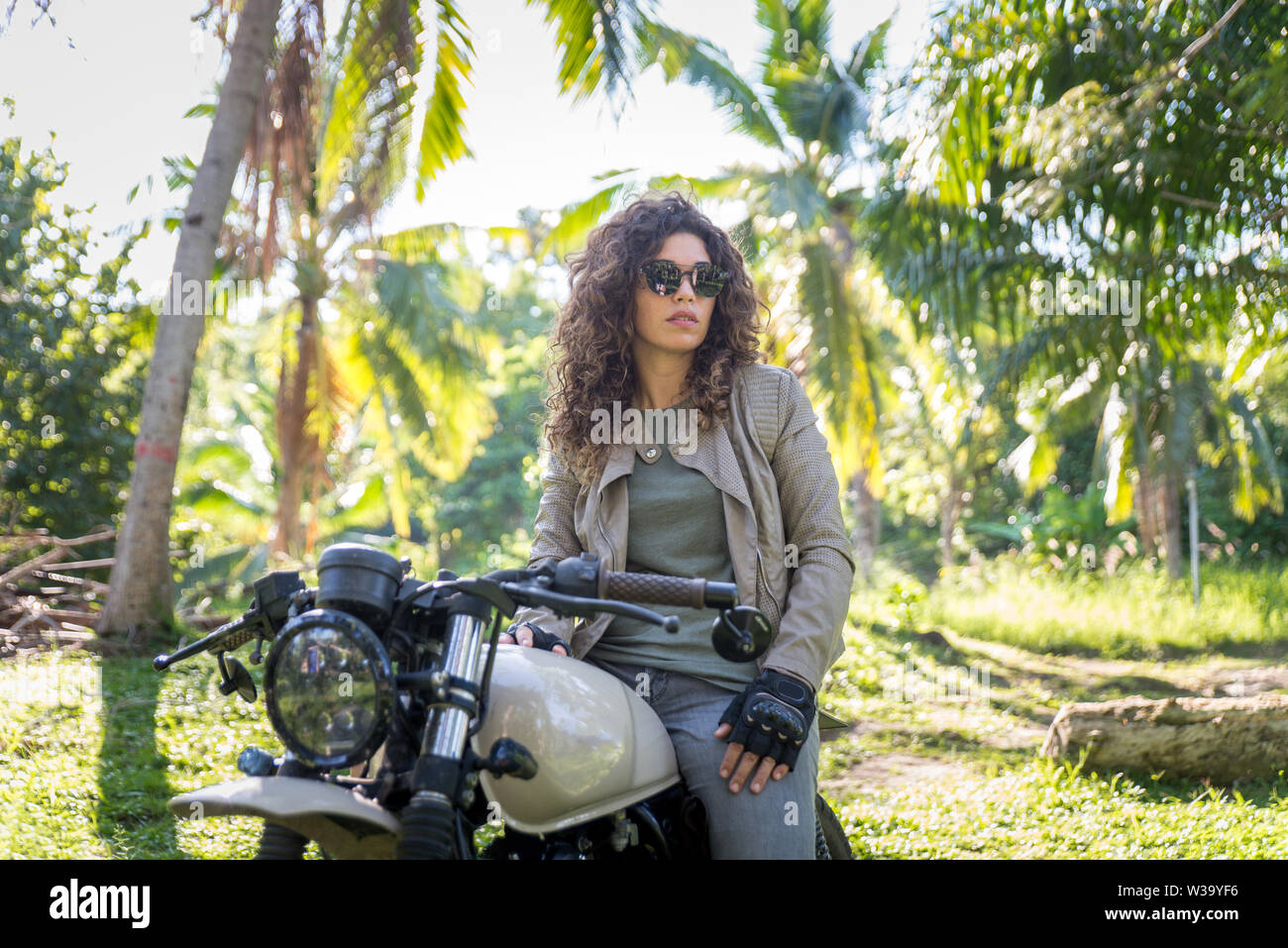 Beautiful female biker driving a cafe' racer motorbike - Pretty girl ...
