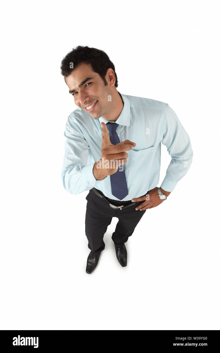 Portrait of a businessman pointing upward Stock Photo - Alamy
