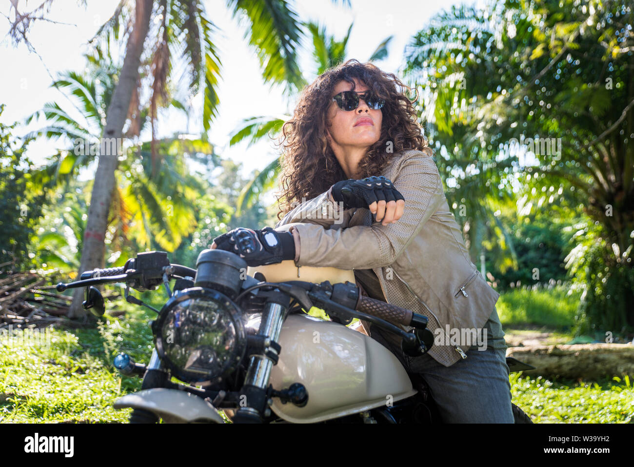 Beautiful female biker driving a cafe' racer motorbike - Pretty girl ...