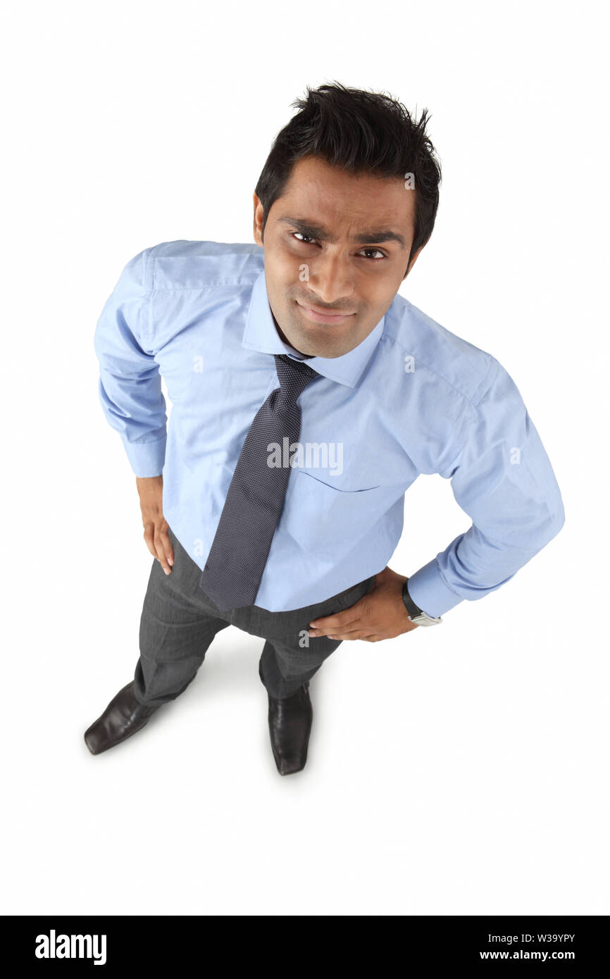 Portrait of a businessman standing with arms akimbo Stock Photo - Alamy