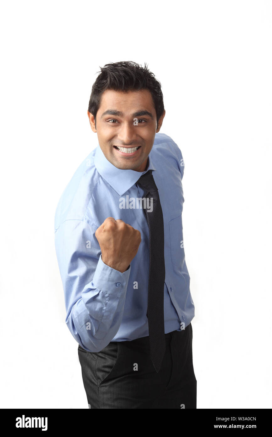 Portrait of a businessman punching the air Stock Photo - Alamy