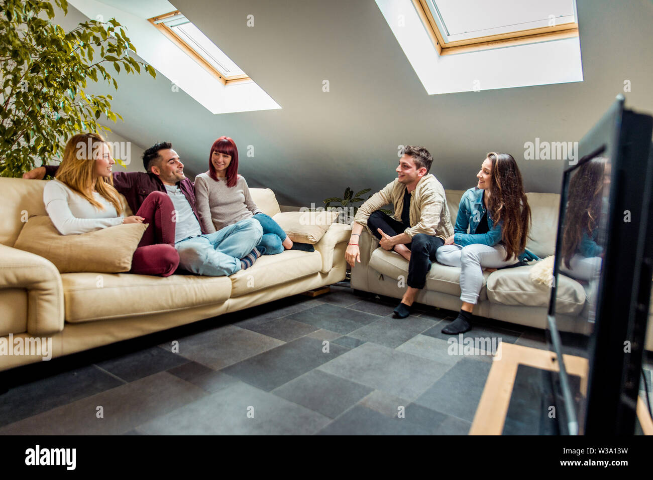 Group of happy friends bonding at home - Young adults having party and ...