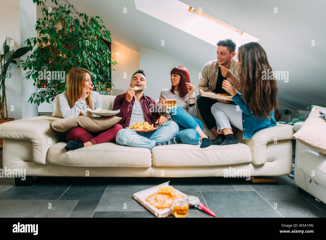 Group of happy friends bonding at home - Young adults having party and ...
