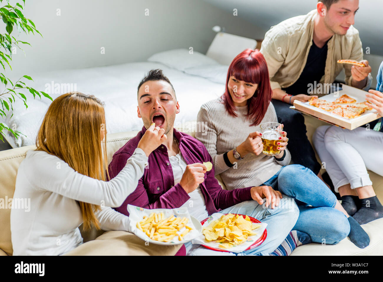 Group of happy friends bonding at home - Young adults having party and ...