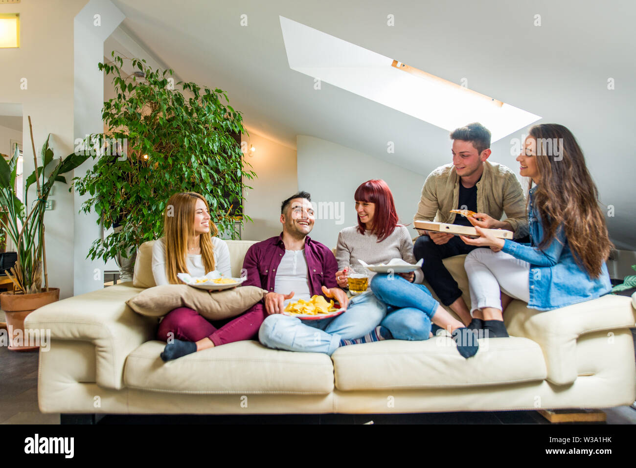 Group of happy friends bonding at home - Young adults having party and ...