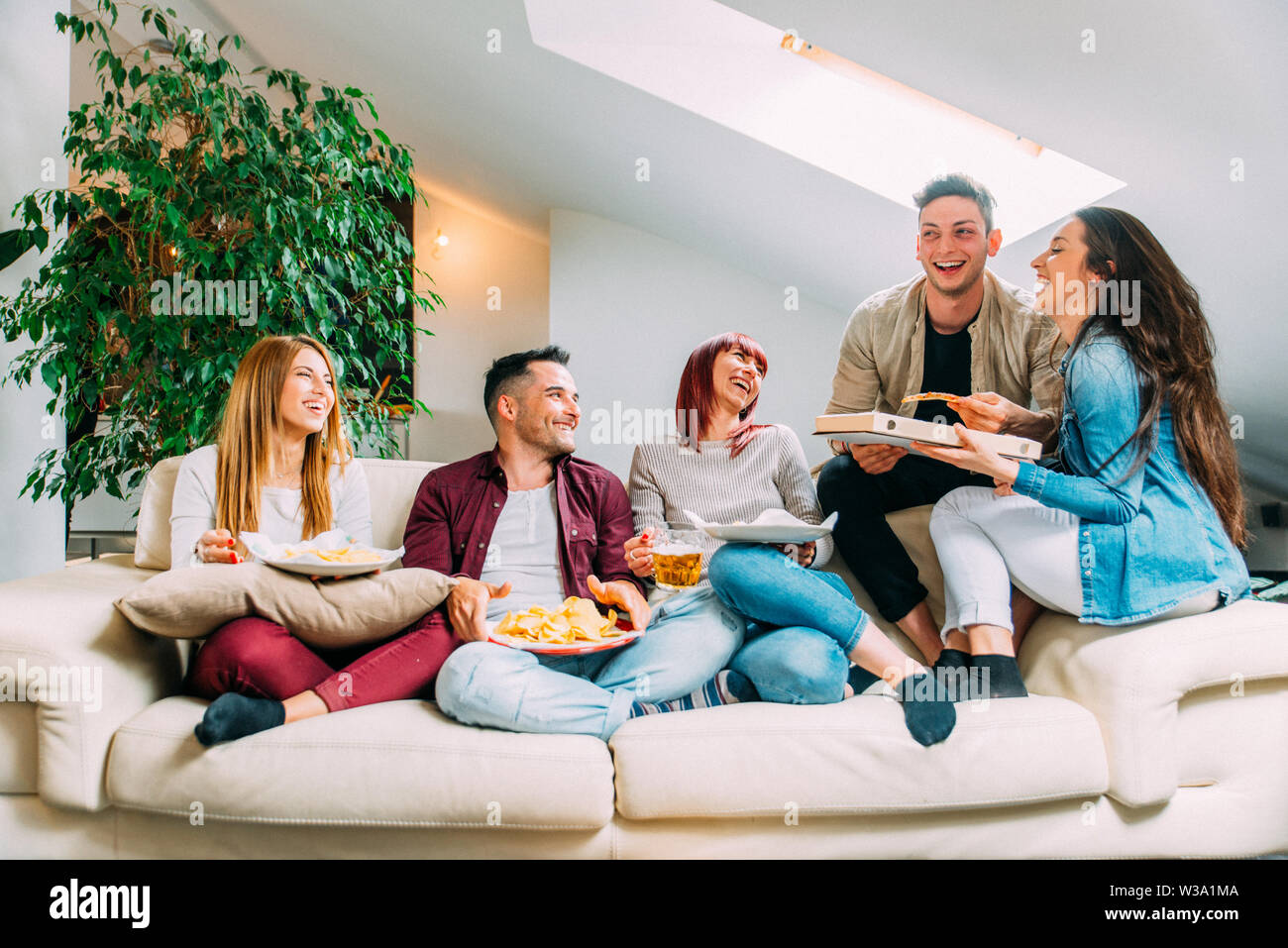 Group of happy friends bonding at home - Young adults having party and ...