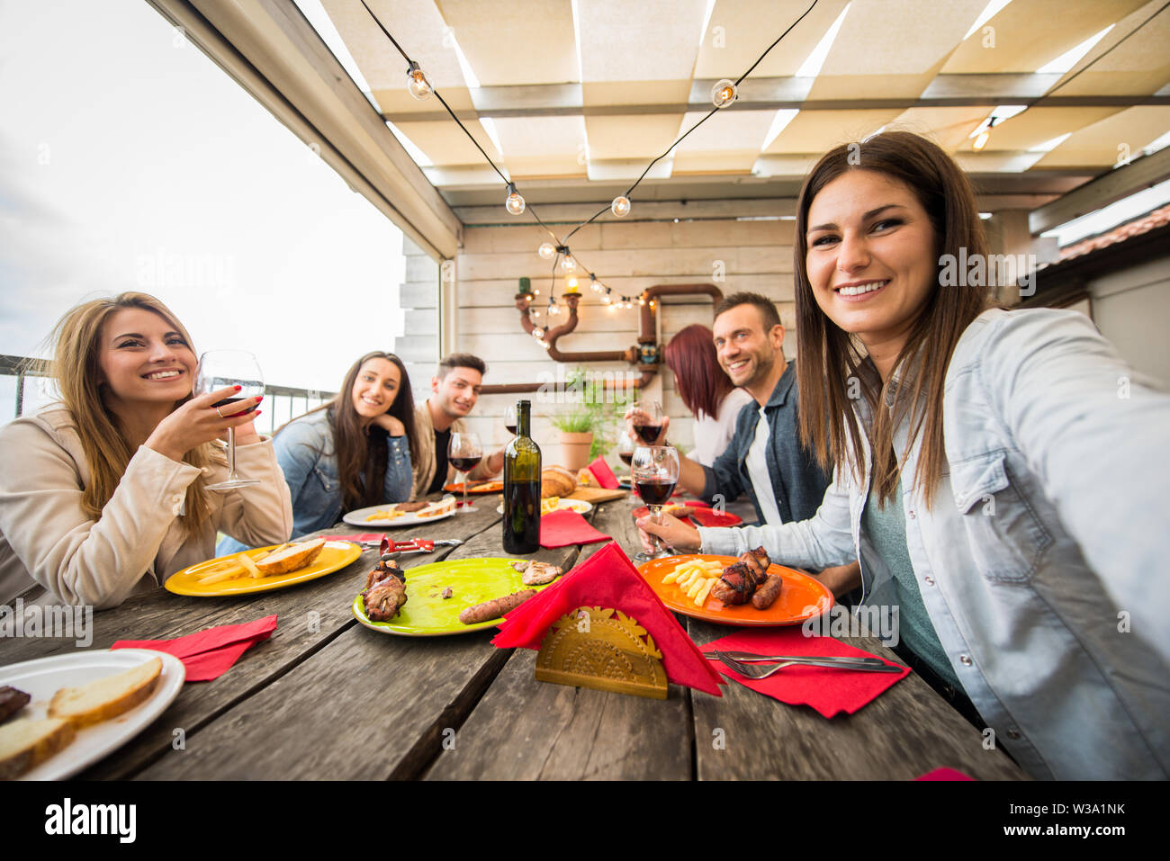 Group of happy friends bonding at home - Young adults having lunch and ...