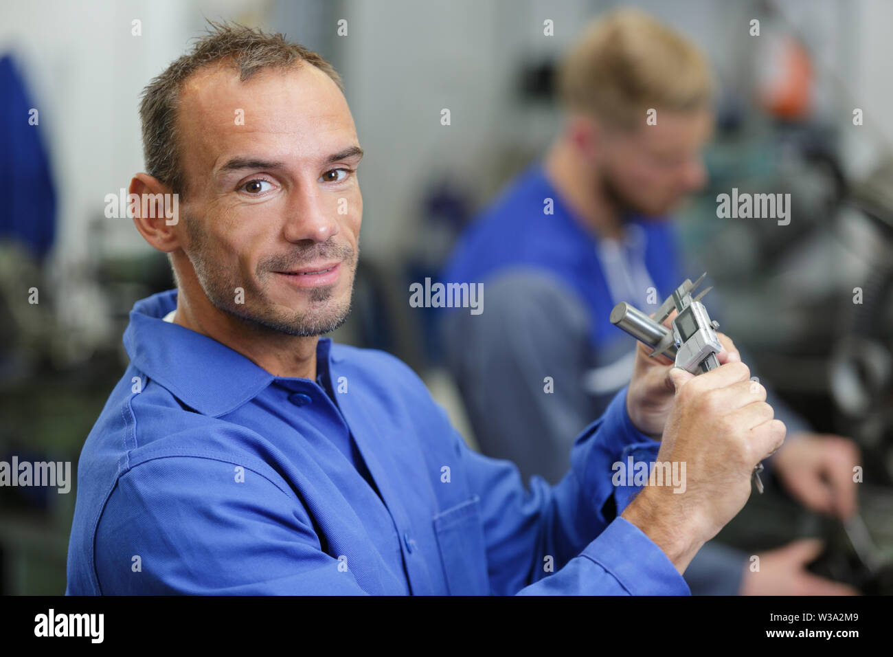 a mechanic assembling mechanical parts Stock Photo - Alamy