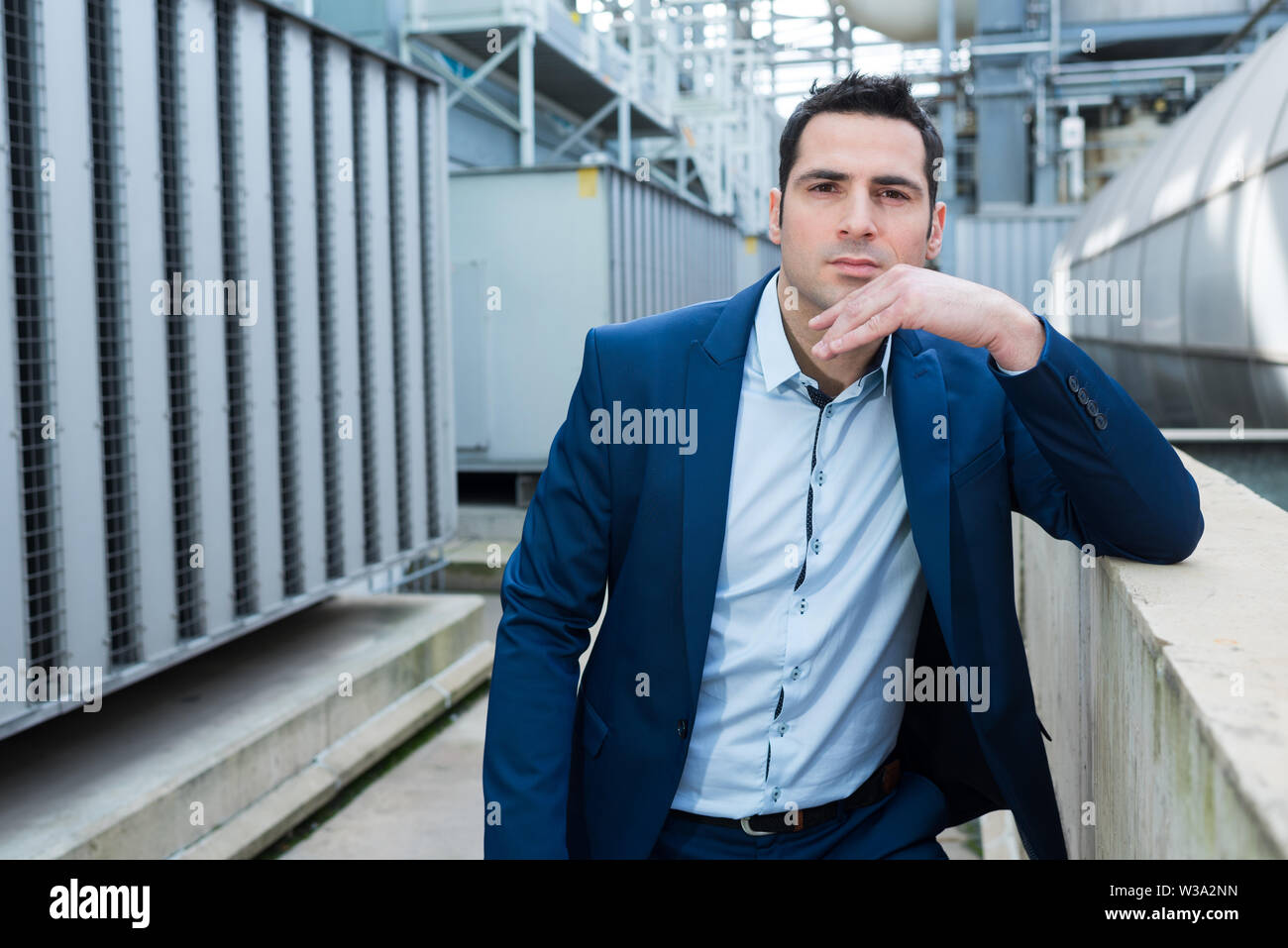 portrait of suited man outdoors on industrial site Stock Photo - Alamy