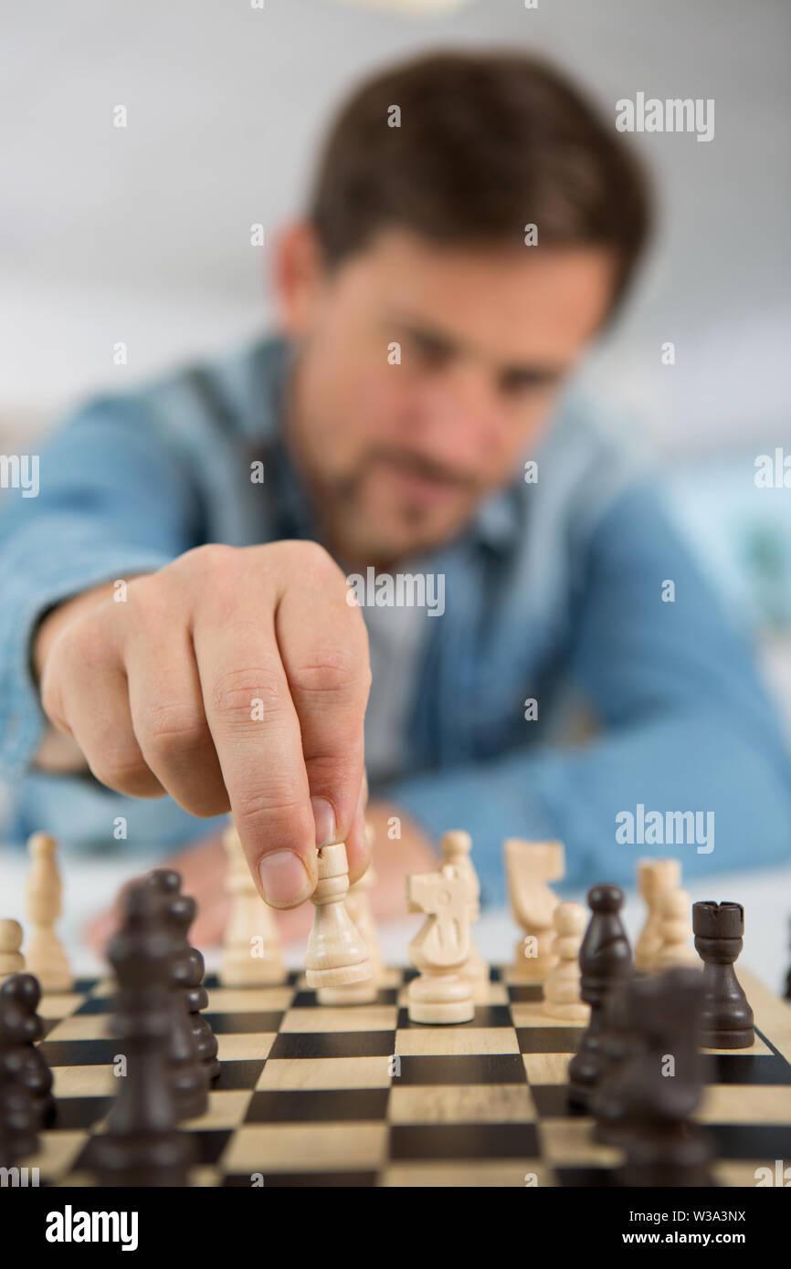 man making his move on the chess board Stock Photo - Alamy