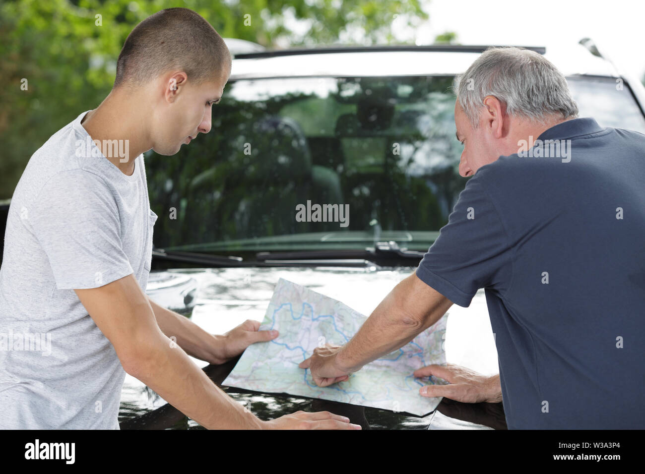son with his father checking a map Stock Photo - Alamy