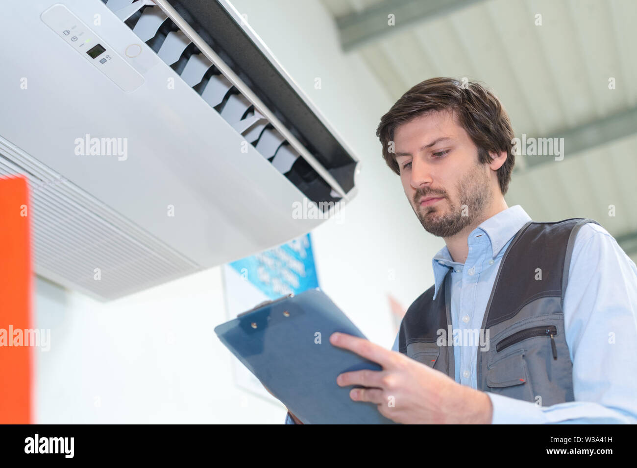 cooler technician doing maintenance check-up Stock Photo - Alamy